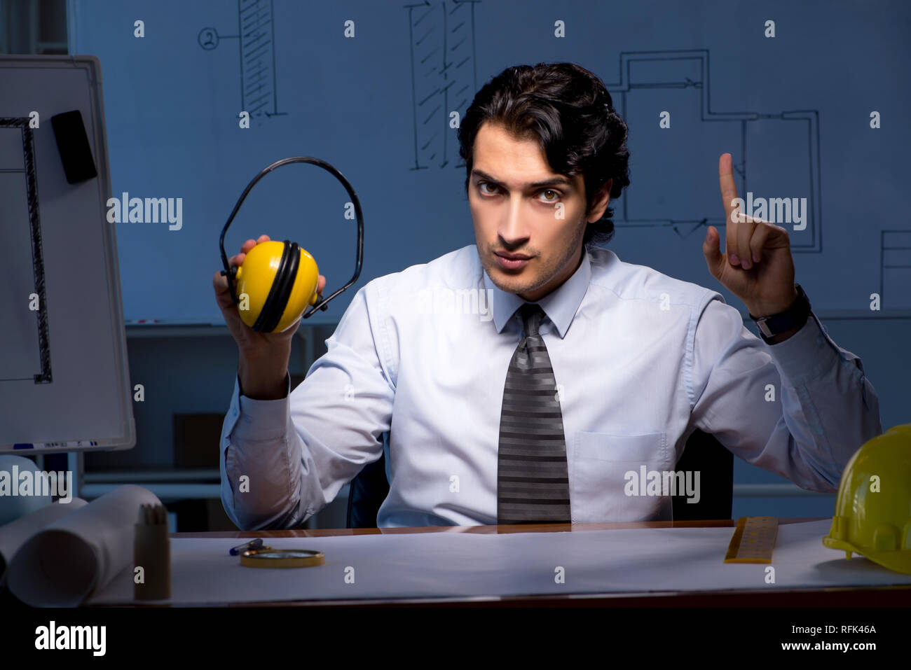 Young construction architect working on project at night Stock Photo ...