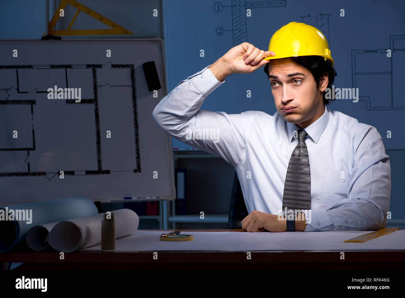 Young construction architect working on project at night Stock Photo ...