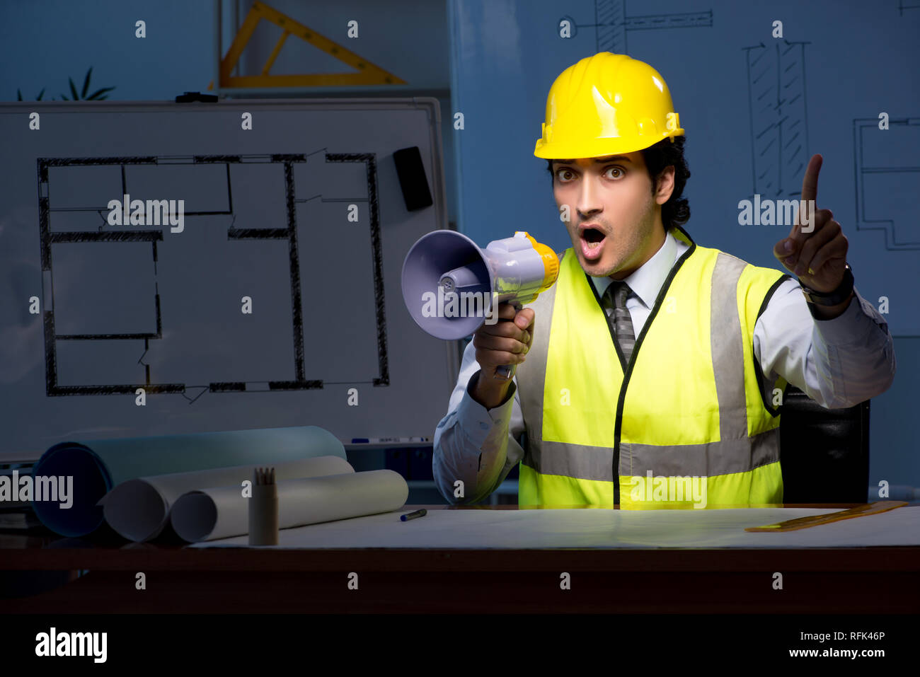 Young construction architect working on project at night Stock Photo ...