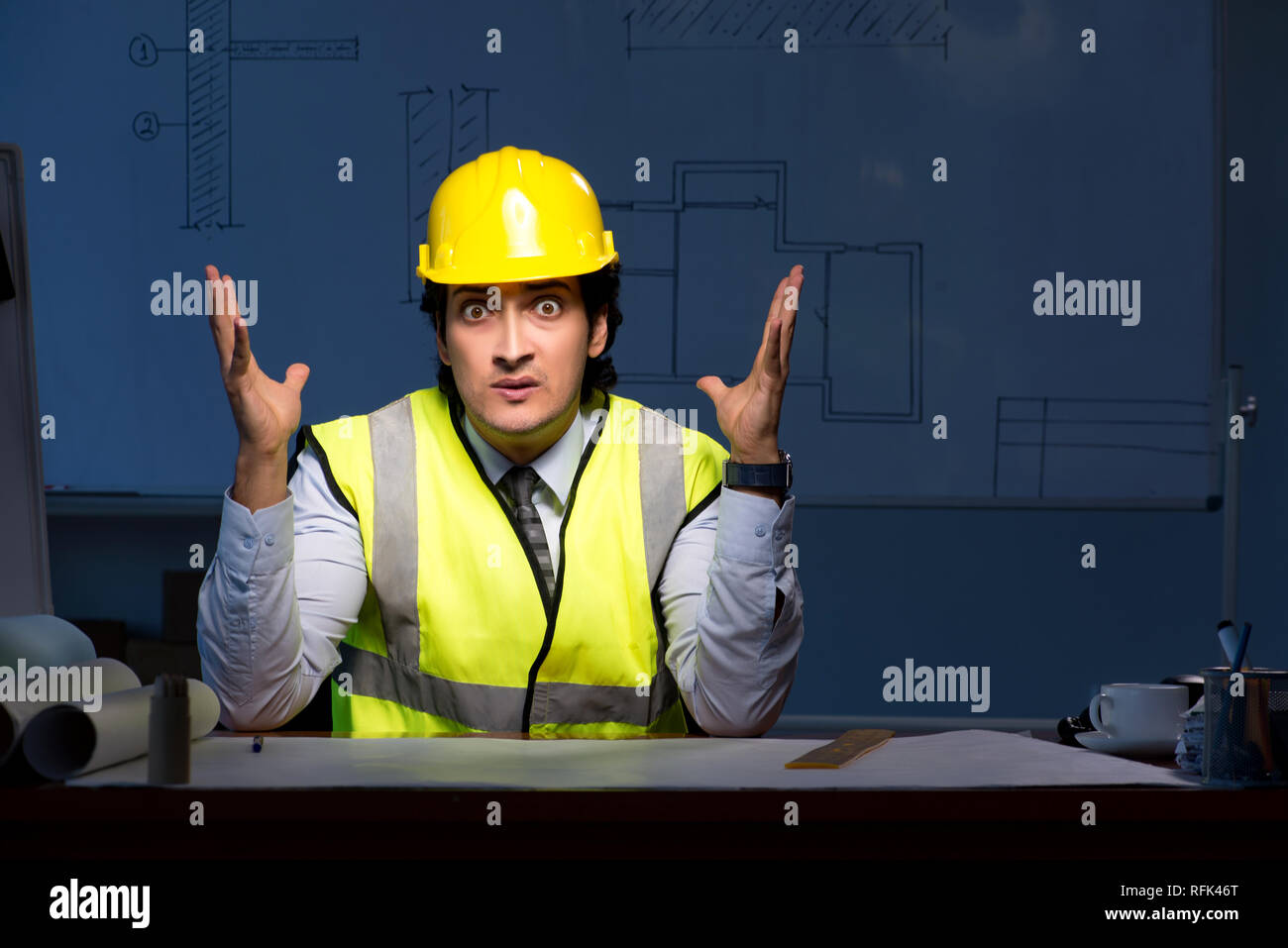 Young construction architect working on project at night Stock Photo ...