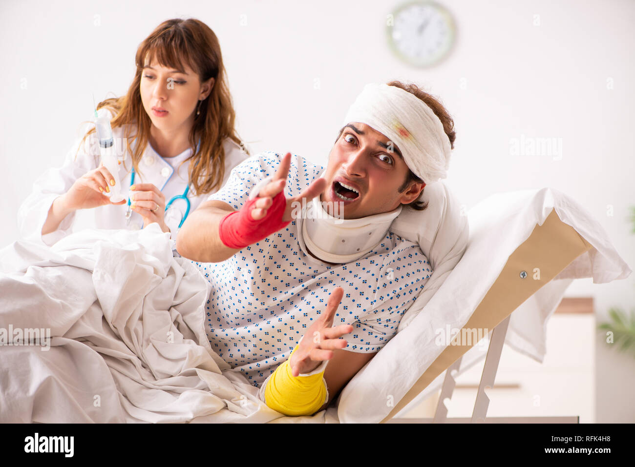 Young doctor examining injured patient Stock Photo - Alamy
