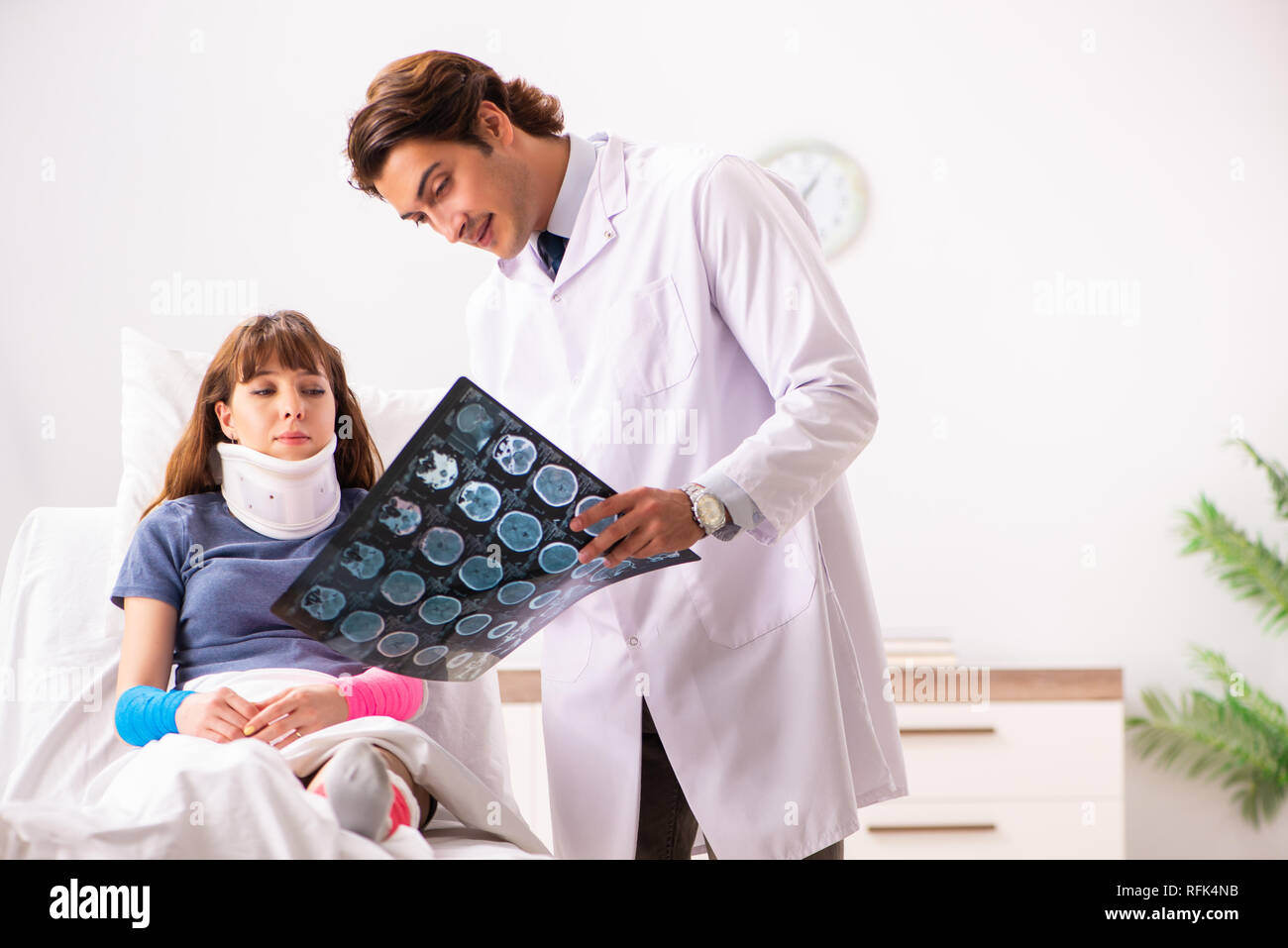 Young doctor examining injured patient Stock Photo - Alamy