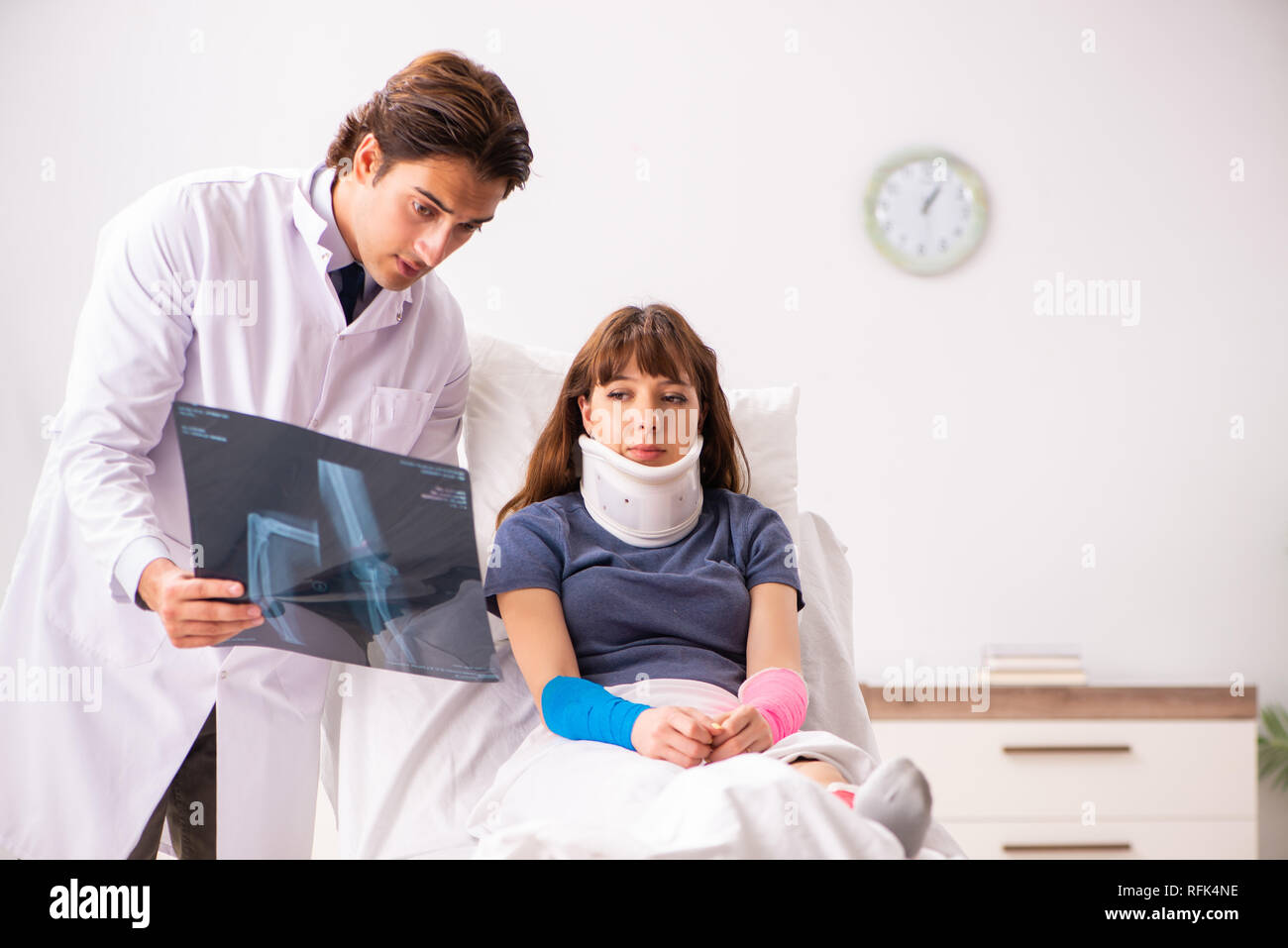 Young doctor examining injured patient Stock Photo - Alamy