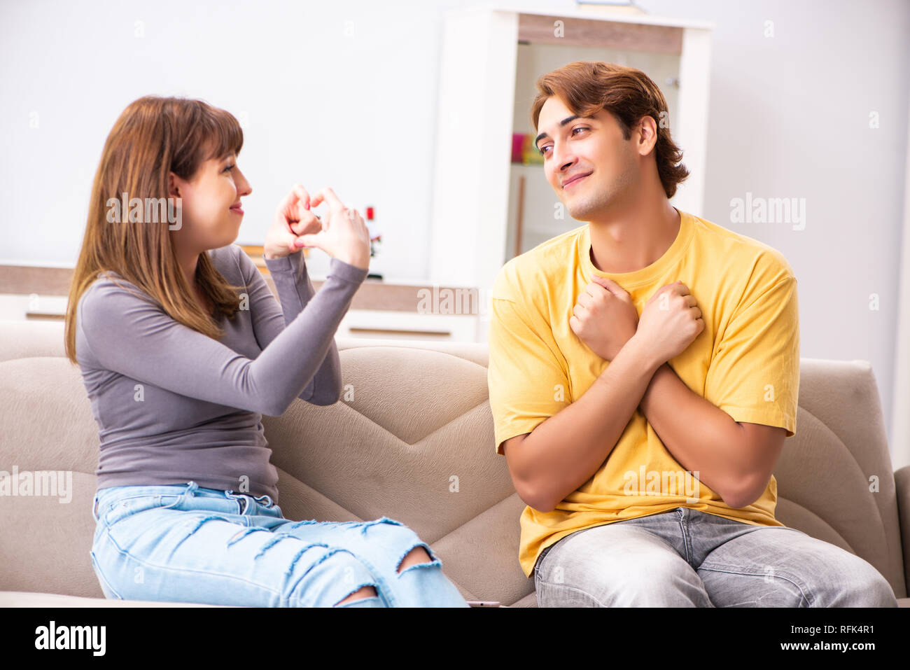 Woman and man learning sign language Stock Photo - Alamy