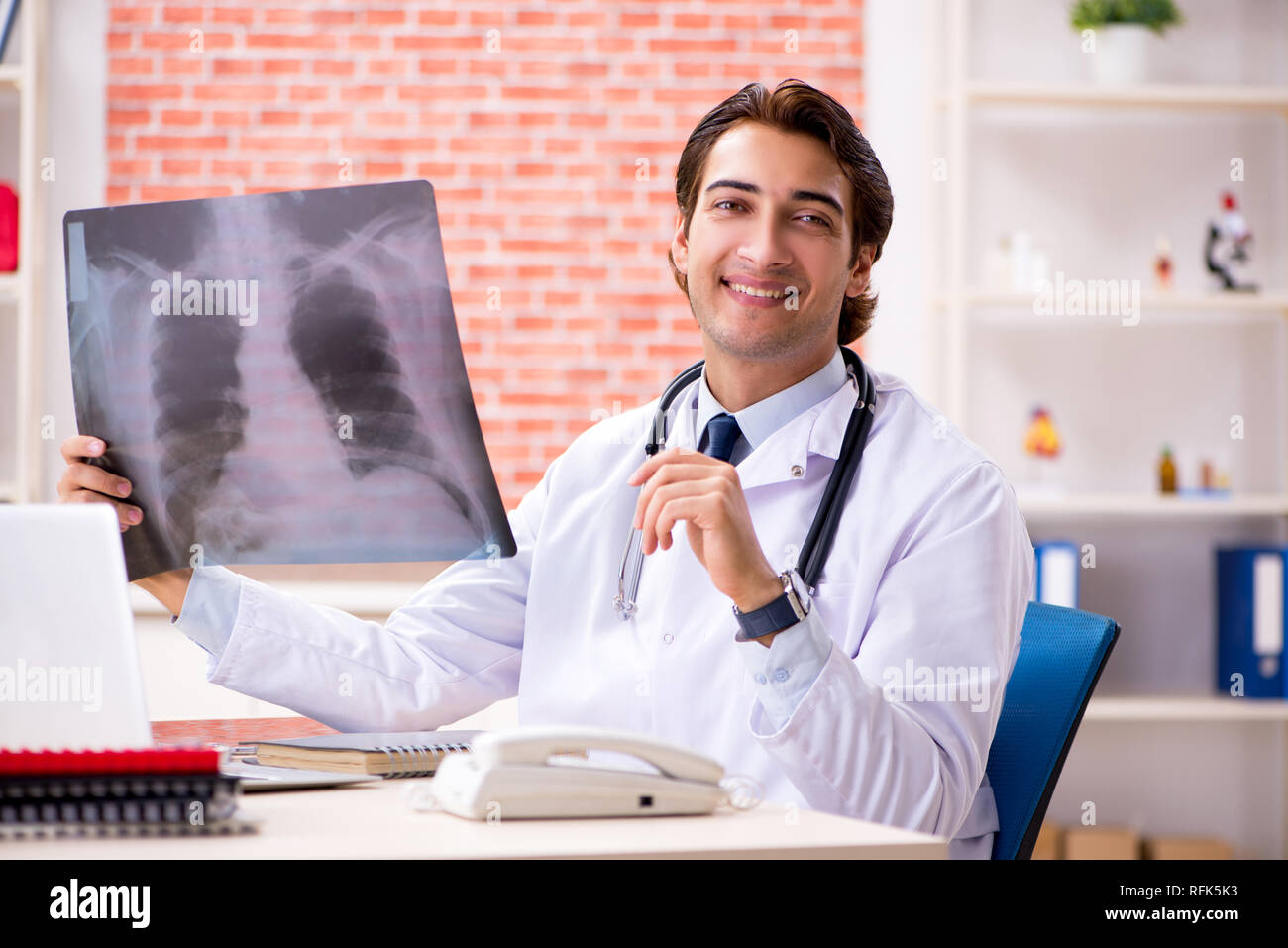 Young doctor working in hospital Stock Photo - Alamy