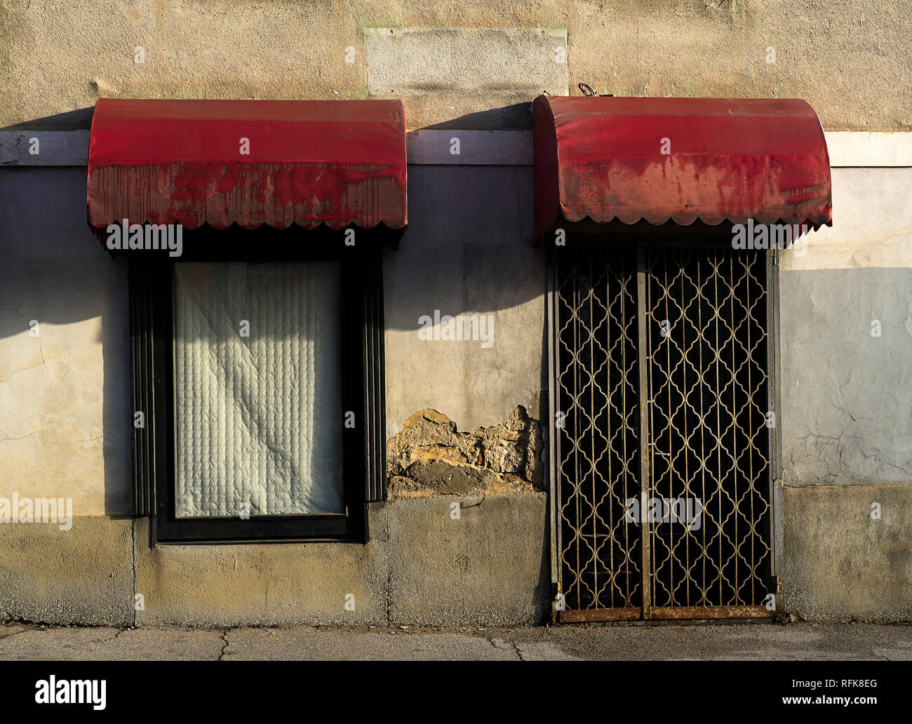 Old abandoned building with metal frame door and blinded window Stock ...