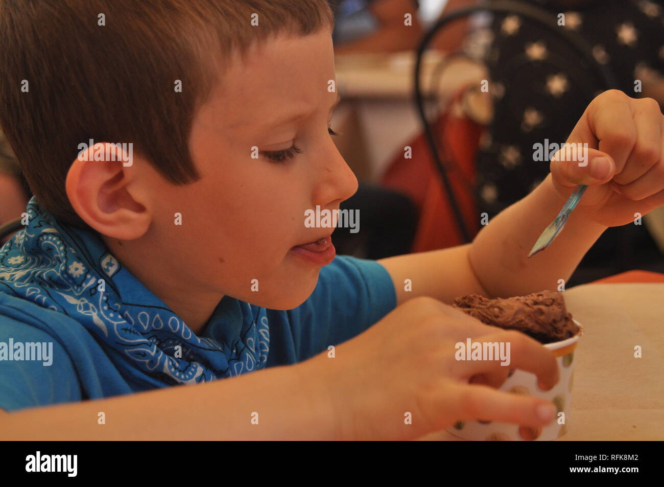 Boy eating blue chocolate ice hi-res stock photography and images - Alamy