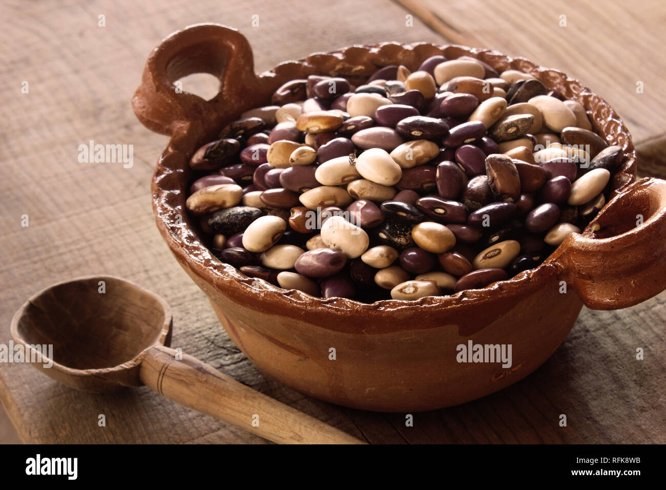 mexican hand made clay pot full with a wide variety of bean seeds ...