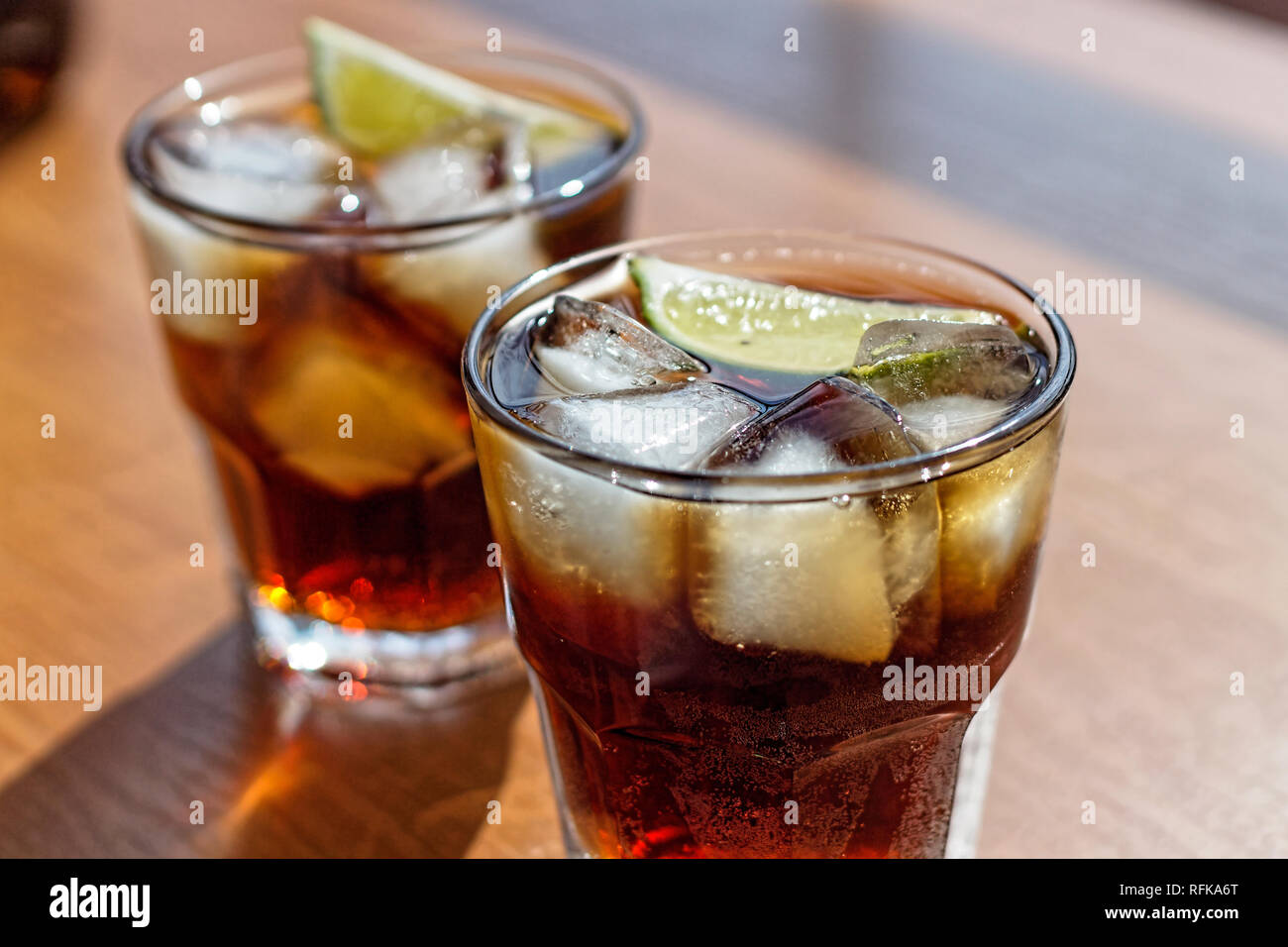 Rum. Cola Cuba Libre with Lime and Ice Stock Photo - Alamy