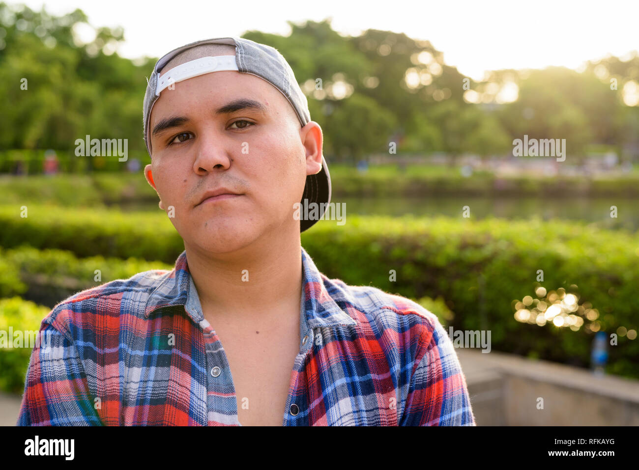 Young Asian man wearing cap while relaxing at the park in Bangko Stock ...
