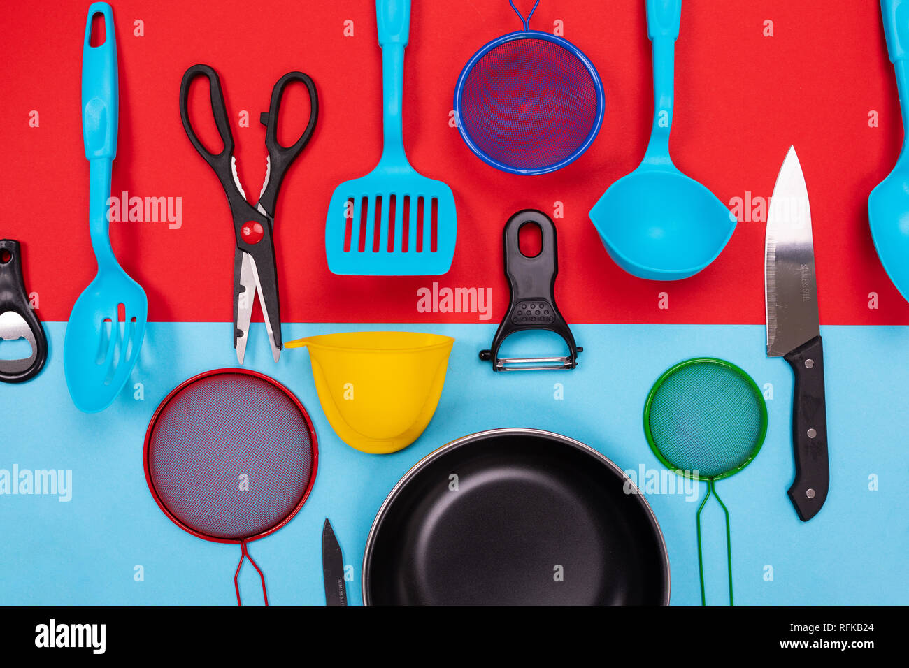 Kitchen utensils isolated on red-blue background Stock Photo - Alamy