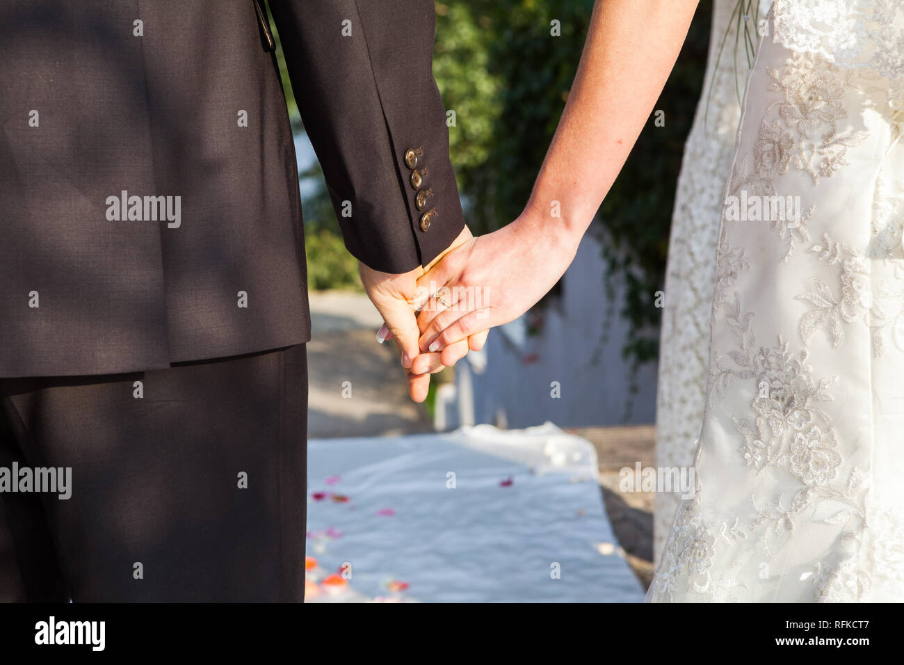 The groom holds the bride by the hand during the wedding ceremony Stock ...