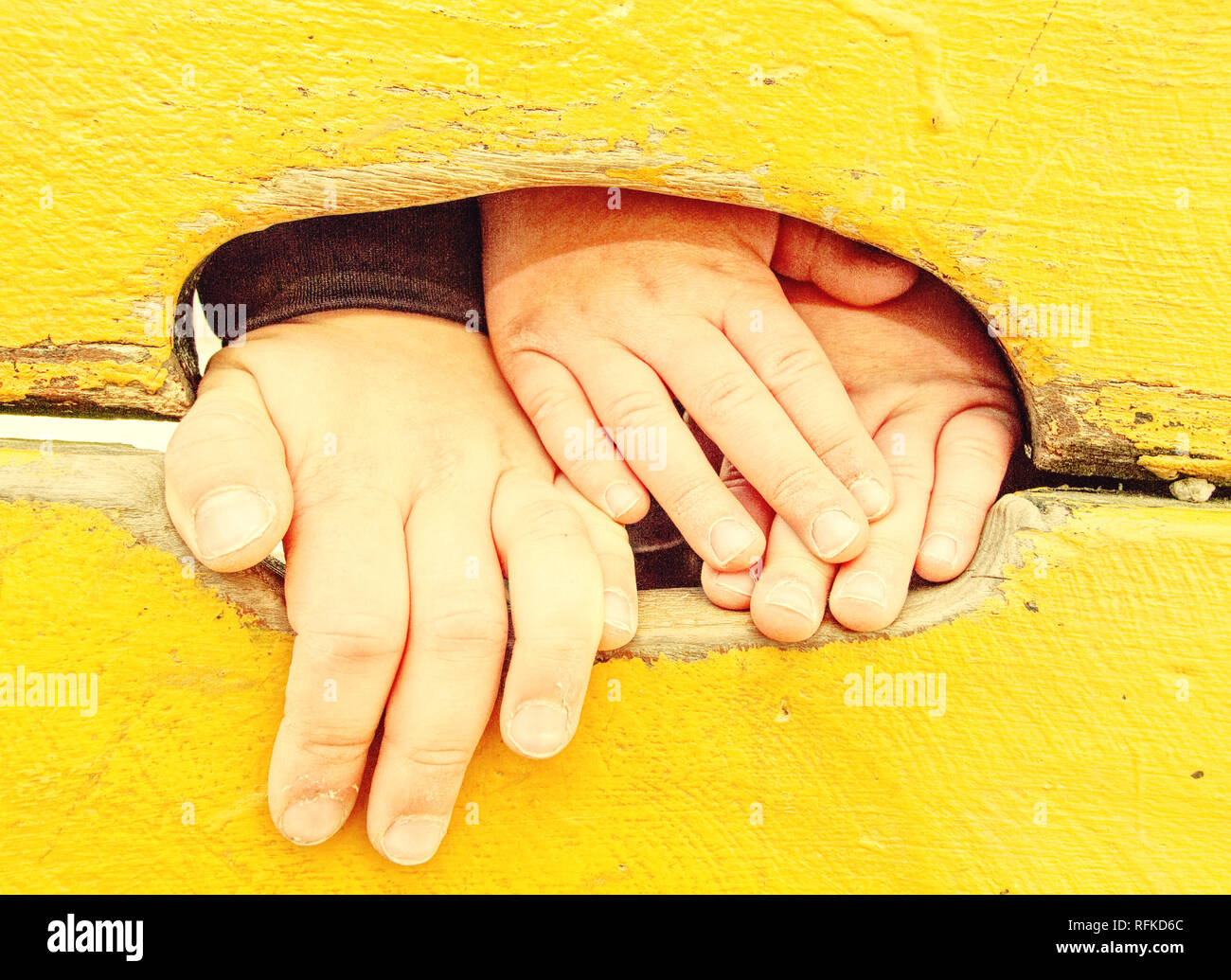 Children hand with small fingers. Hand and footholds on a wooden ...