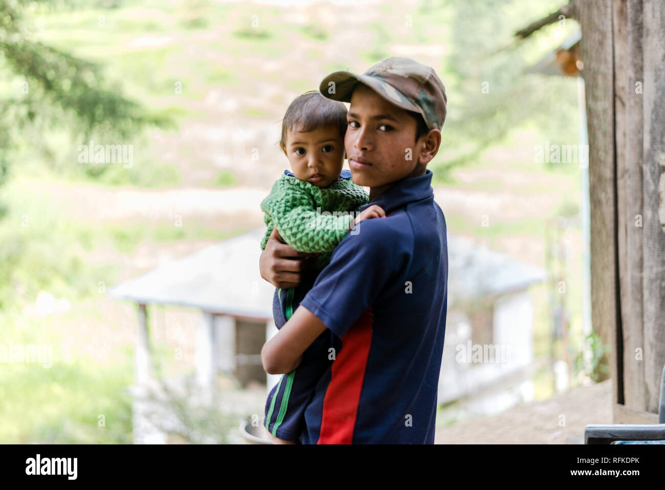 Photo of Boy with baby in himalayas, Great Himalayan National Park ...