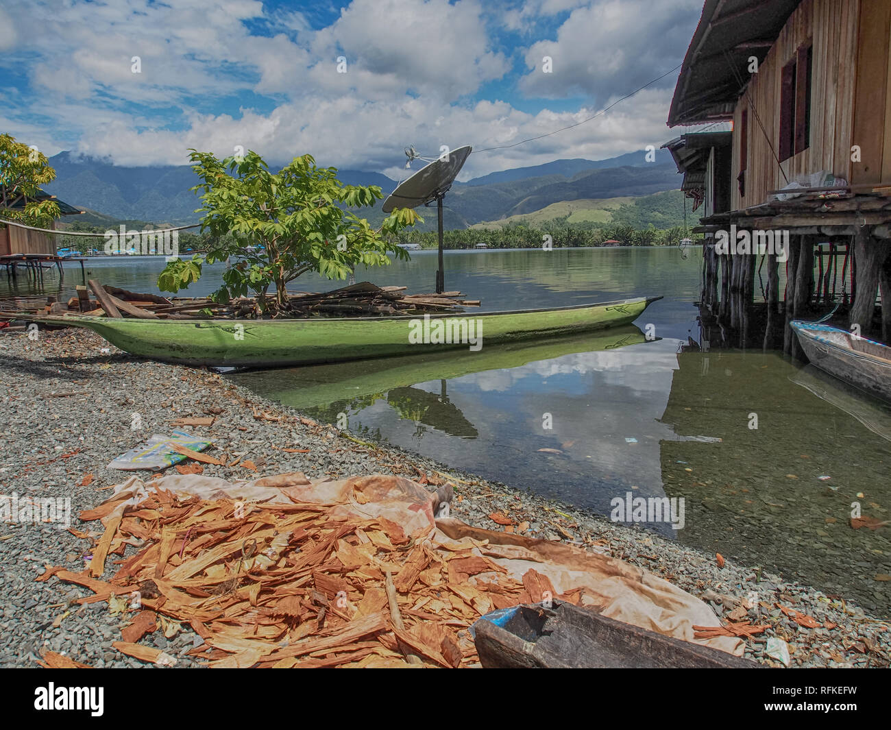 Jayapura, Indonesia - January 24, 2015: Stilt houses and wooden green ...