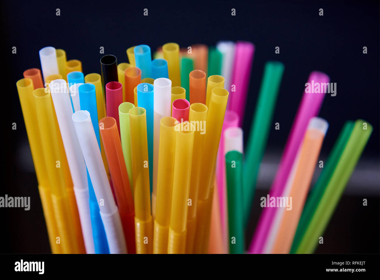 Multi Colored straws close-up on a dark background Stock Photo - Alamy