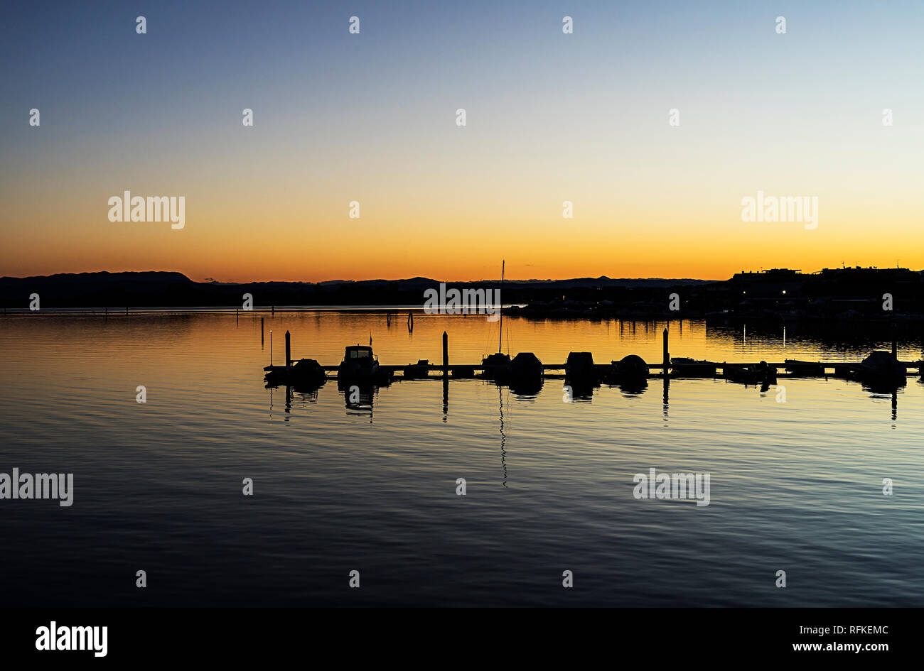 Small fishing boats floating on water Stock Photo - Alamy
