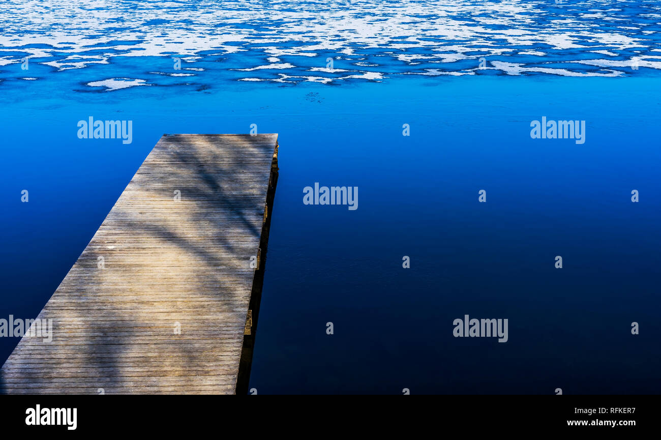 Small wooden docks above cold water in winter Stock Photo - Alamy