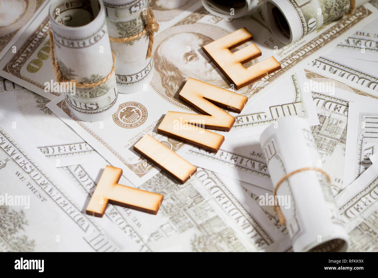 Time is money, dollar bills and time text Stock Photo - Alamy