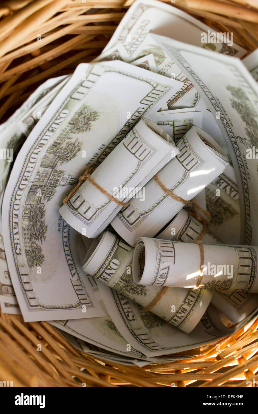 Dollar bills inside the basket Stock Photo - Alamy