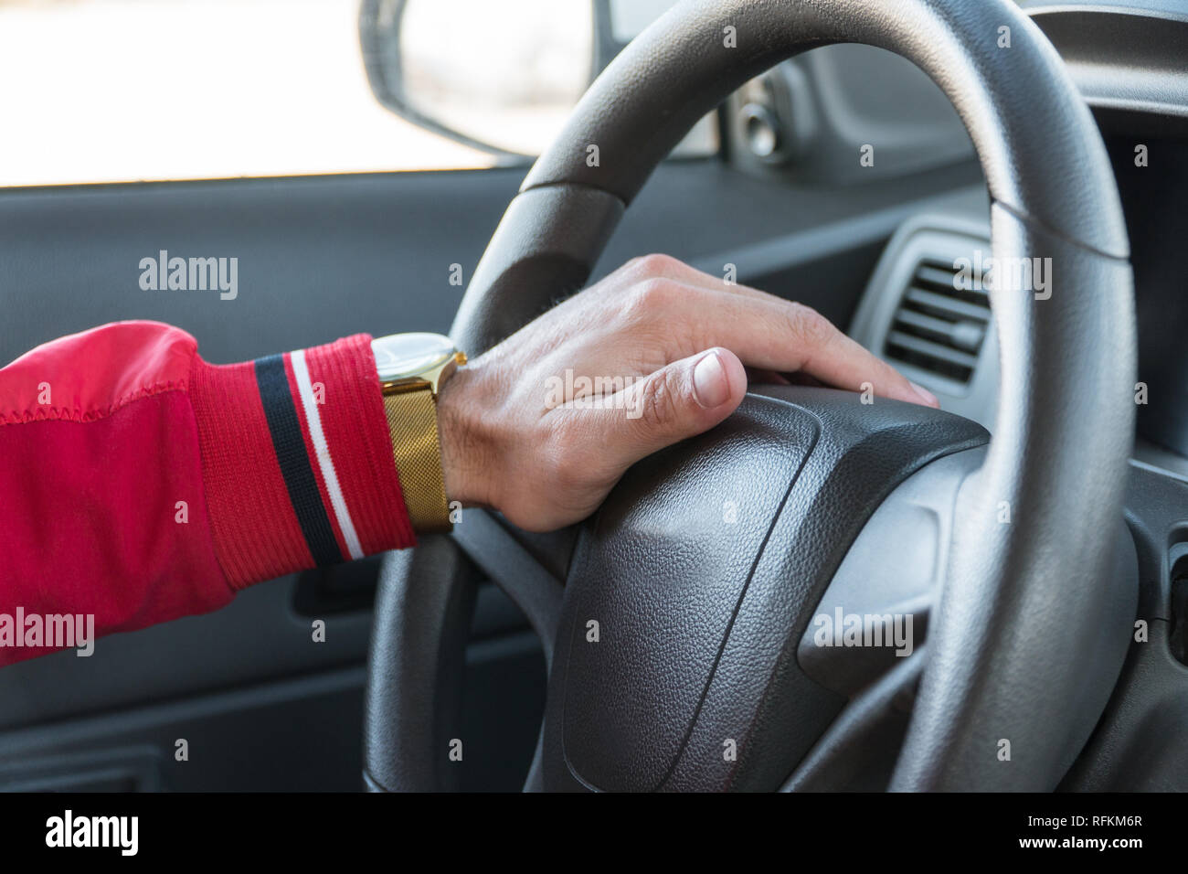 men's hand with a watch on the steering wheel of a modern car Stock ...