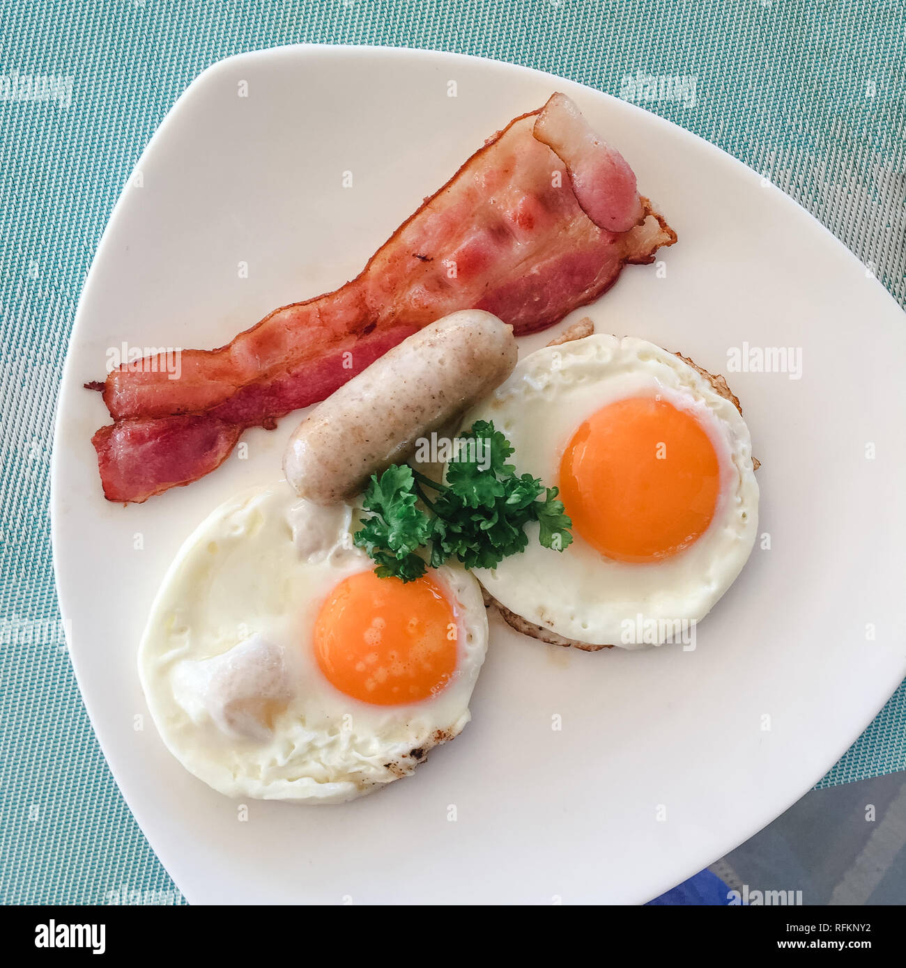 American breakfast. delicious breakfast for one. Woman hands cutting ...