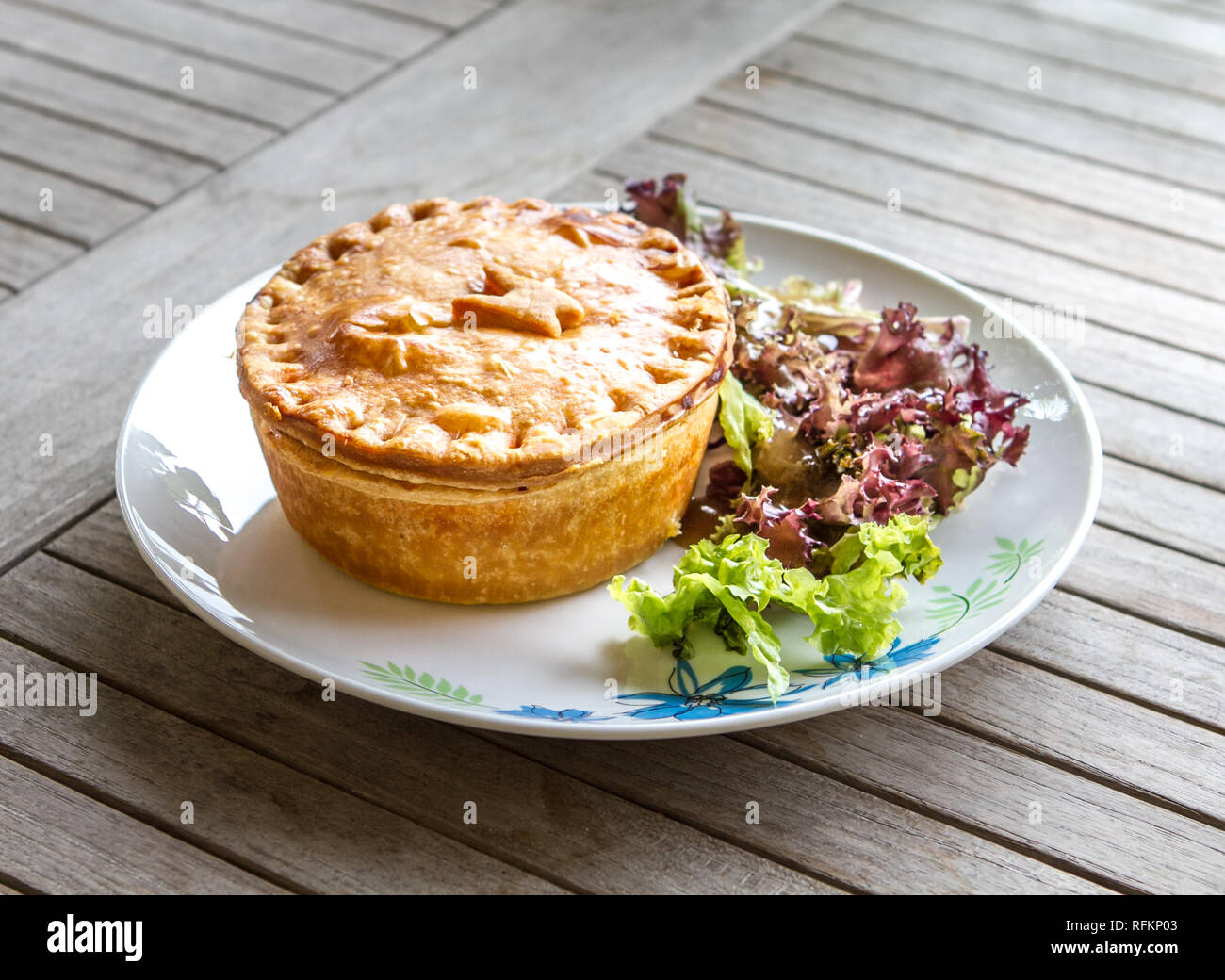 Beef meat pie with salad on the side Stock Photo - Alamy