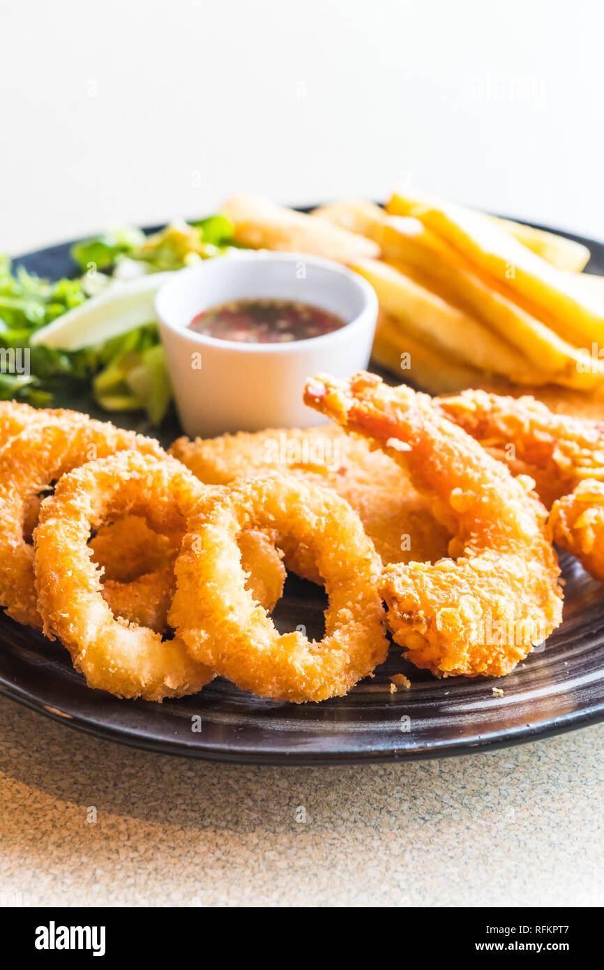 Fried Seafood platter with french fries in black plate Stock Photo - Alamy
