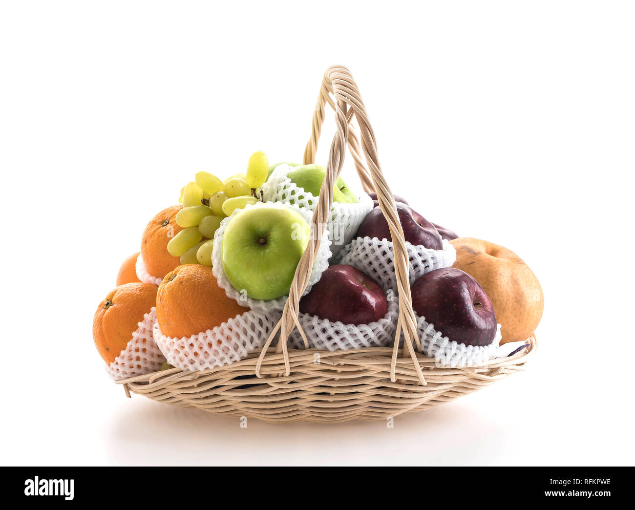Fruits in a basket on white background Stock Photo - Alamy