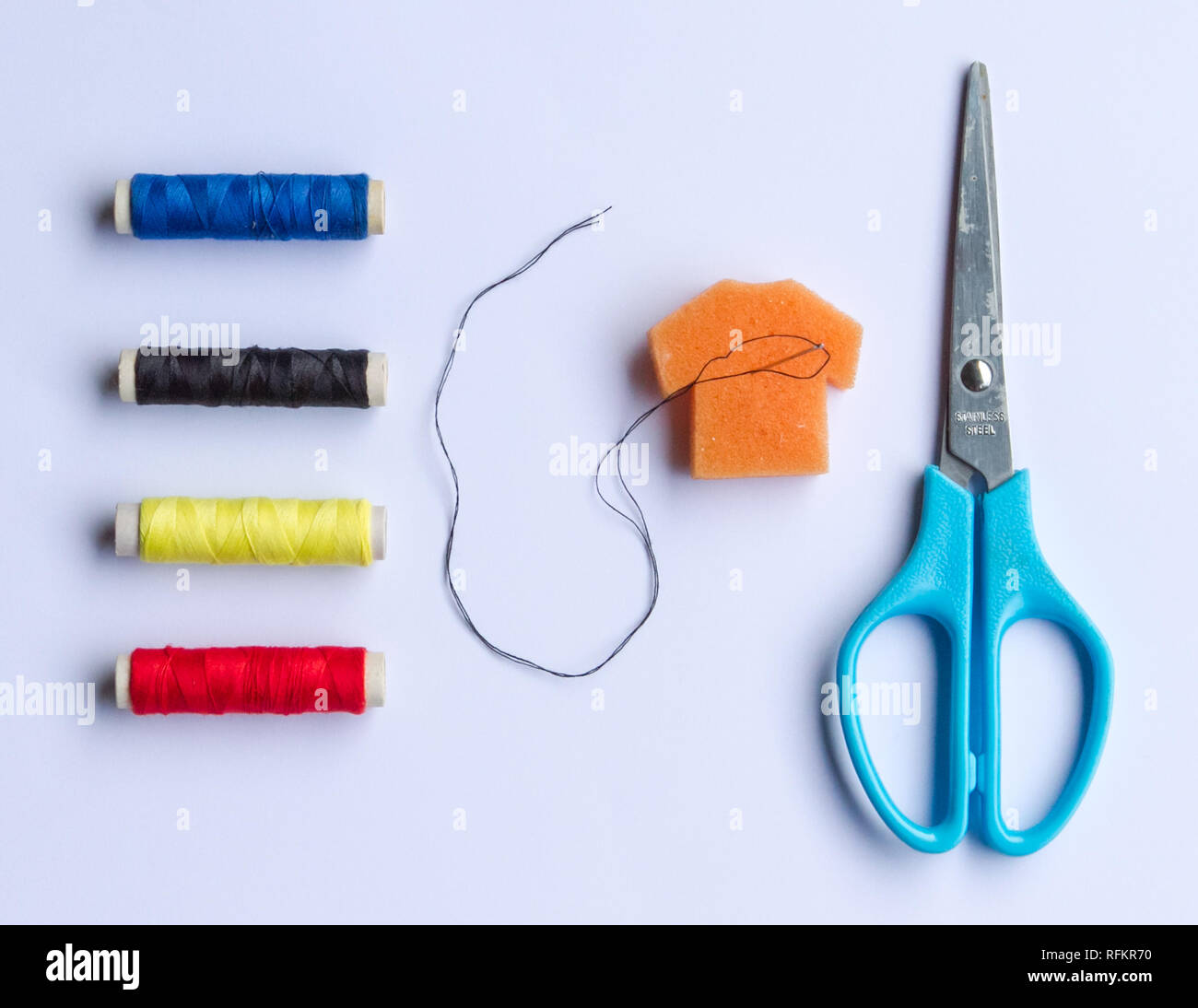 Basic sewing kit with scissors, needle and sewing yarn Stock Photo - Alamy