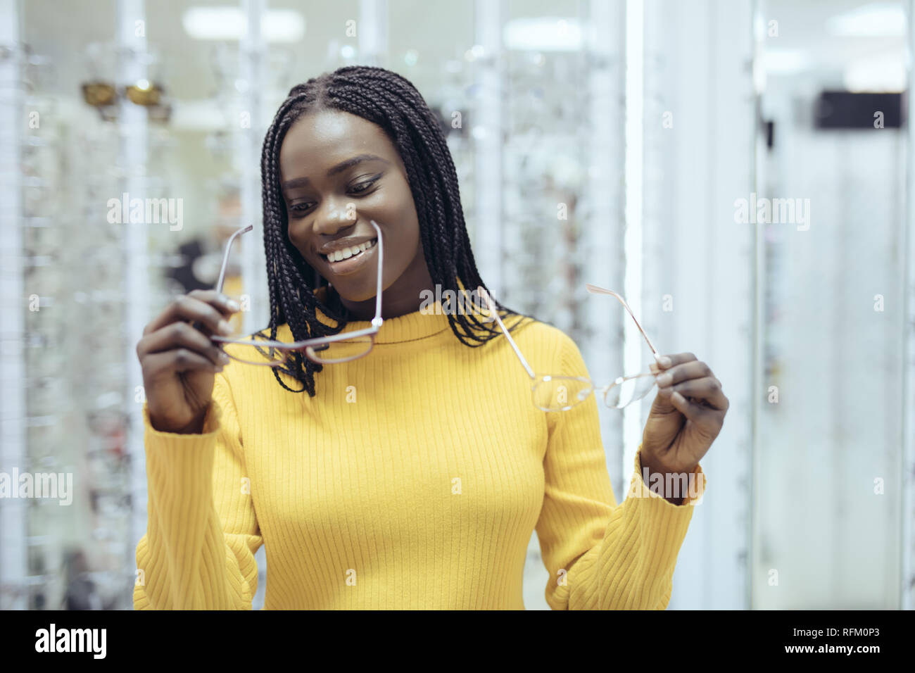 Attractive woman choosing glasses hi-res stock photography and images ...