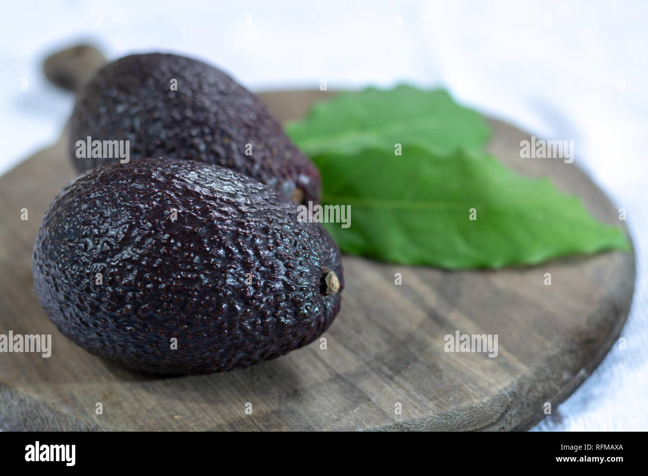 Two whole ripe raw hass avocados, close up, healthy food concept Stock ...