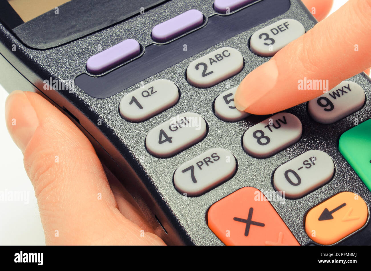 Hand using payment terminal, enter personal identification number ...