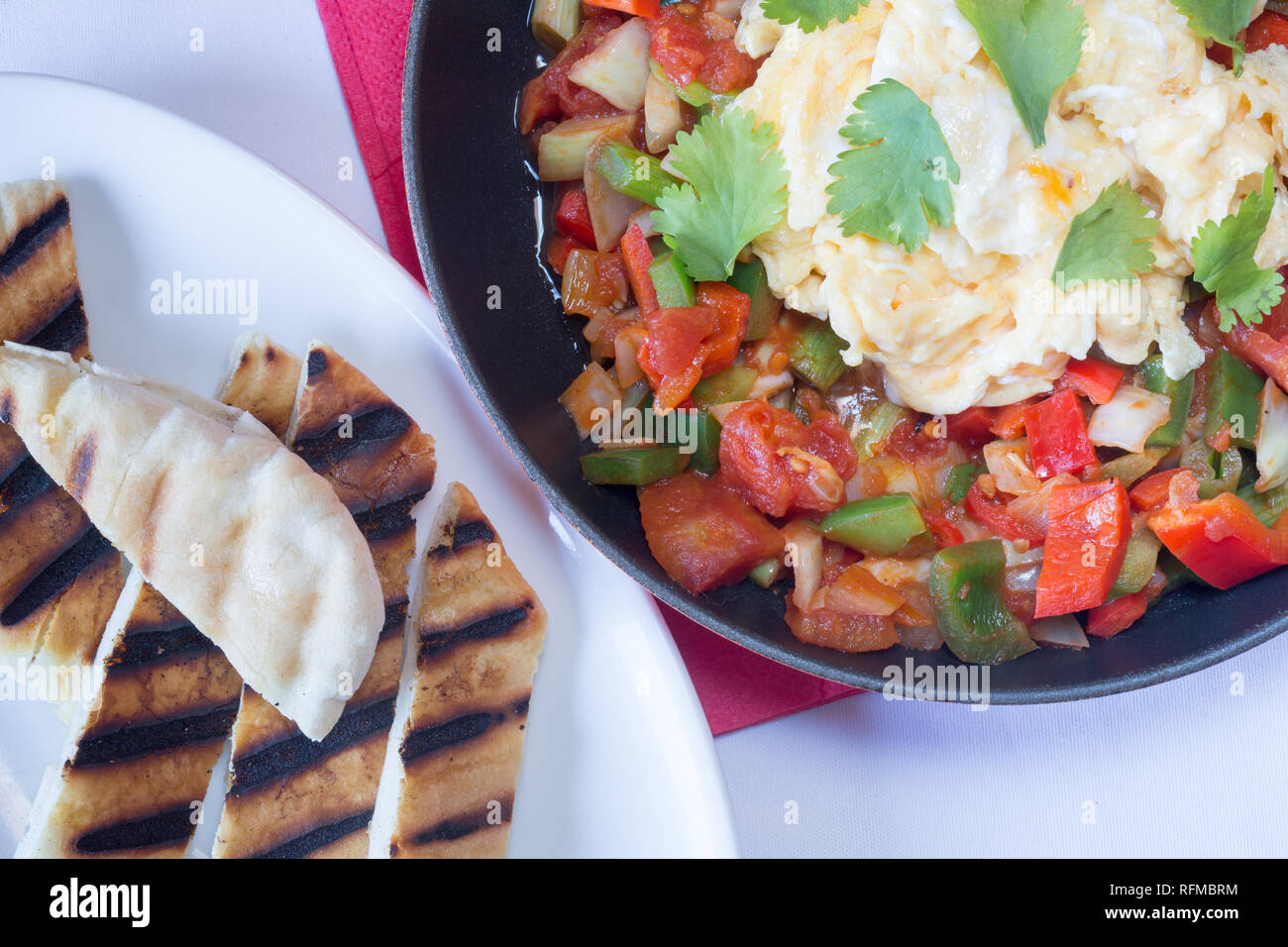 Traditional Turkish breakfast dish of Menemen with flatbread Stock ...