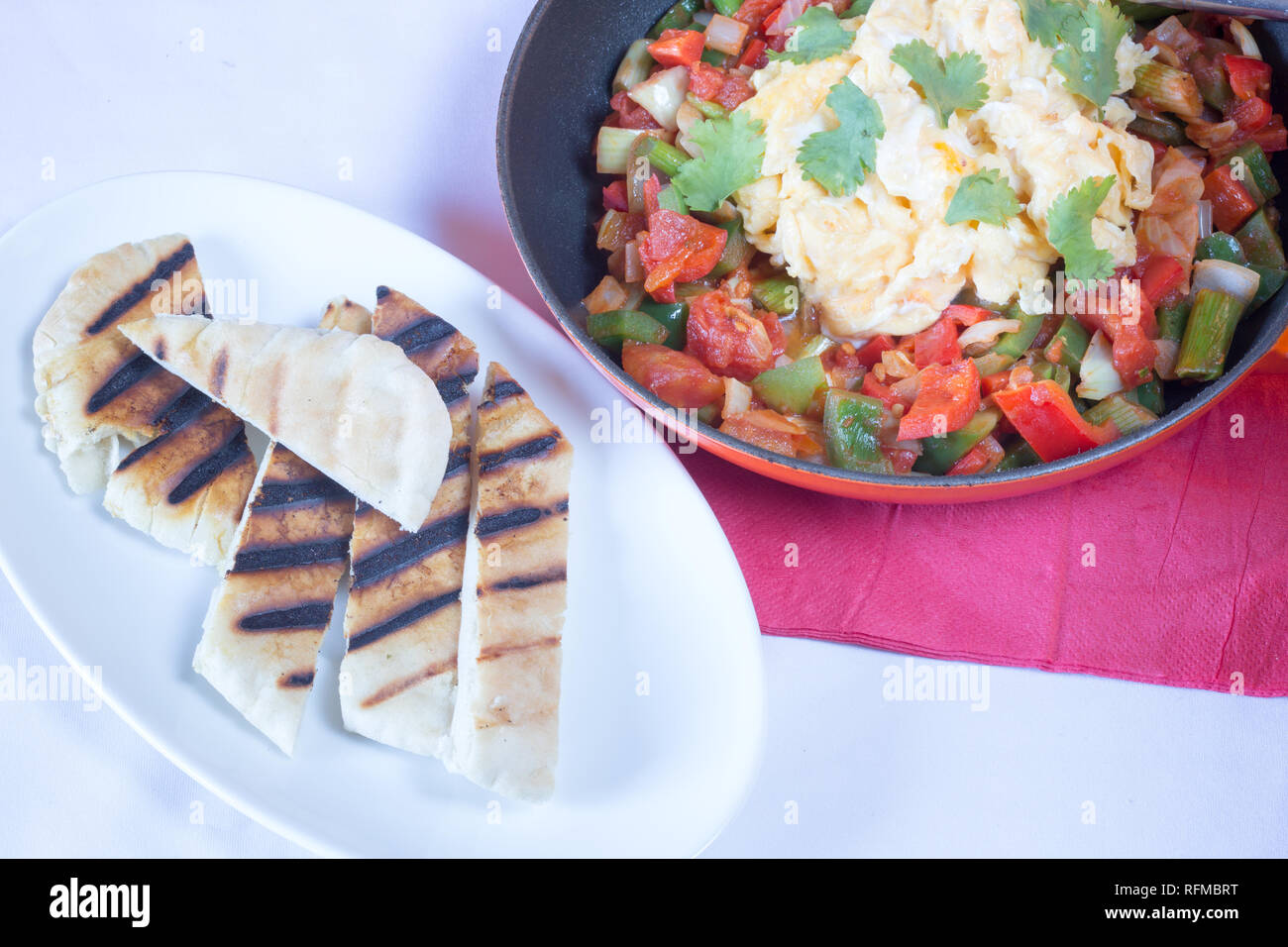 Traditional Turkish breakfast dish of Menemen with flatbread Stock ...