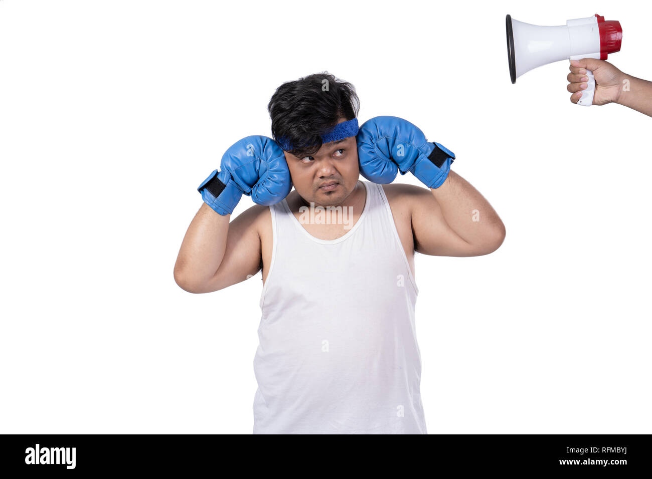 portrait of fat young man close his ears by hands with boxing gloves ...