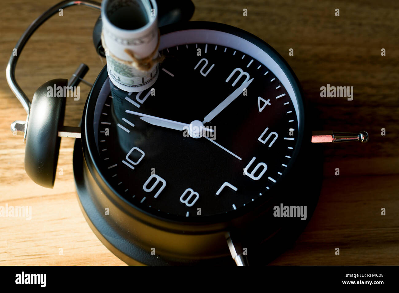 Clock and money, precious time Stock Photo - Alamy