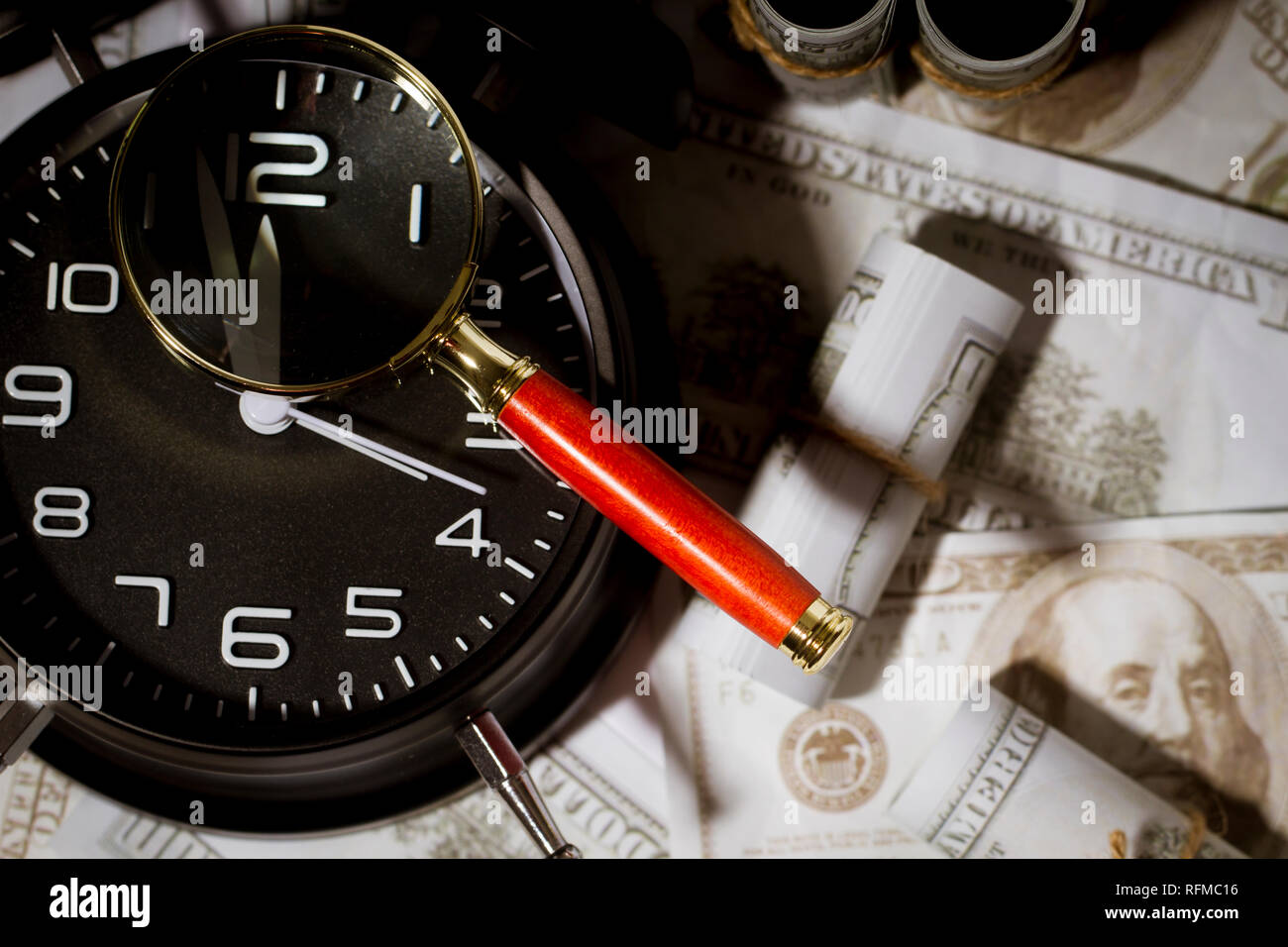 Clock and money, precious time Stock Photo - Alamy