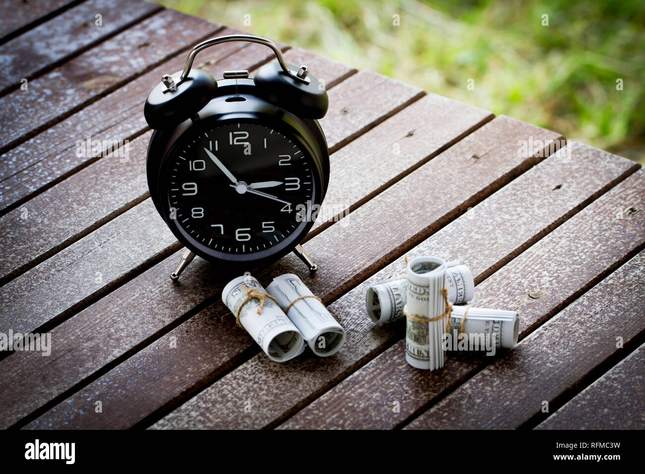 Clock and money, precious time Stock Photo - Alamy