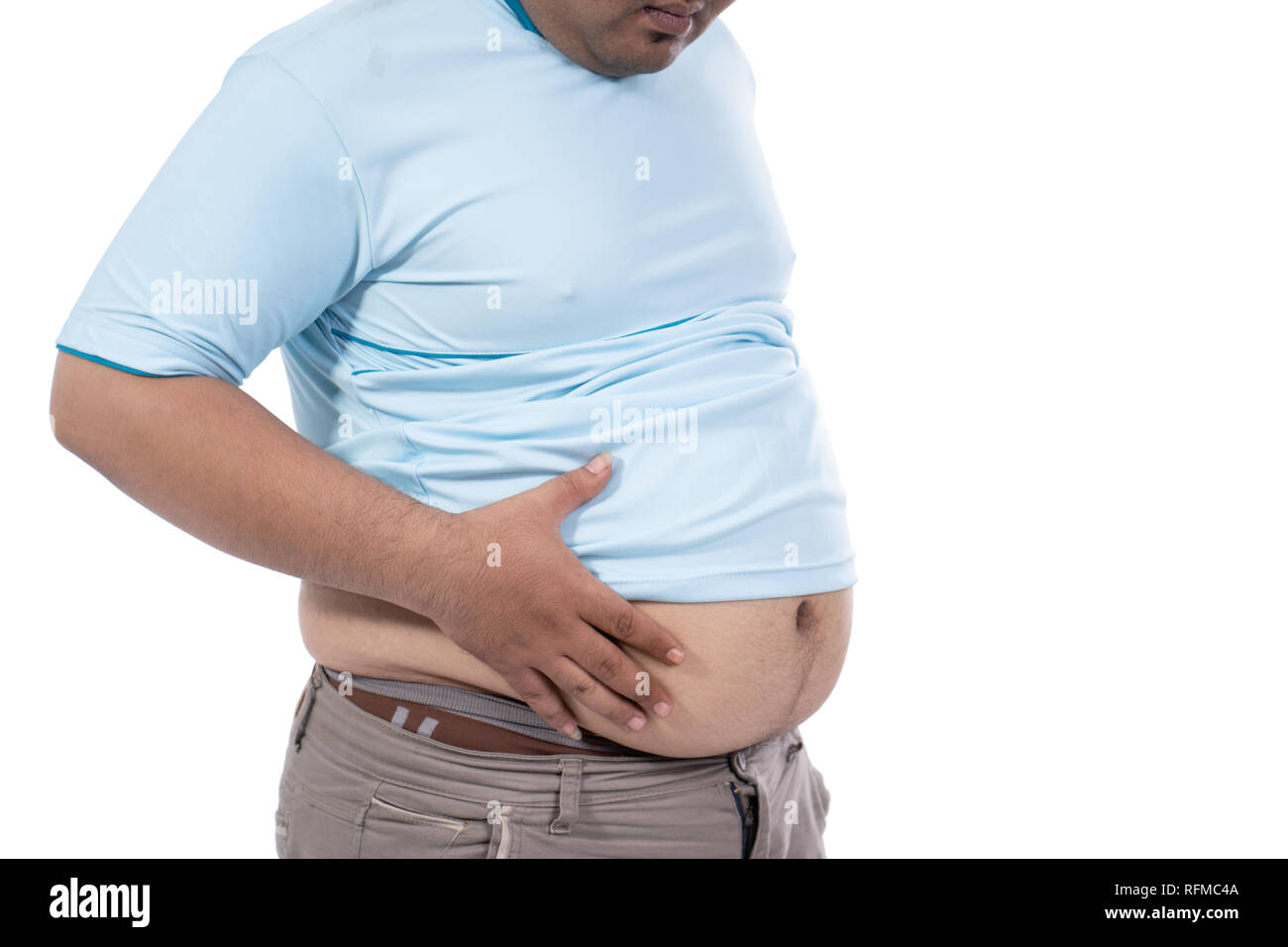 portrait of fat young man pinch excess fat that has around his waist ...