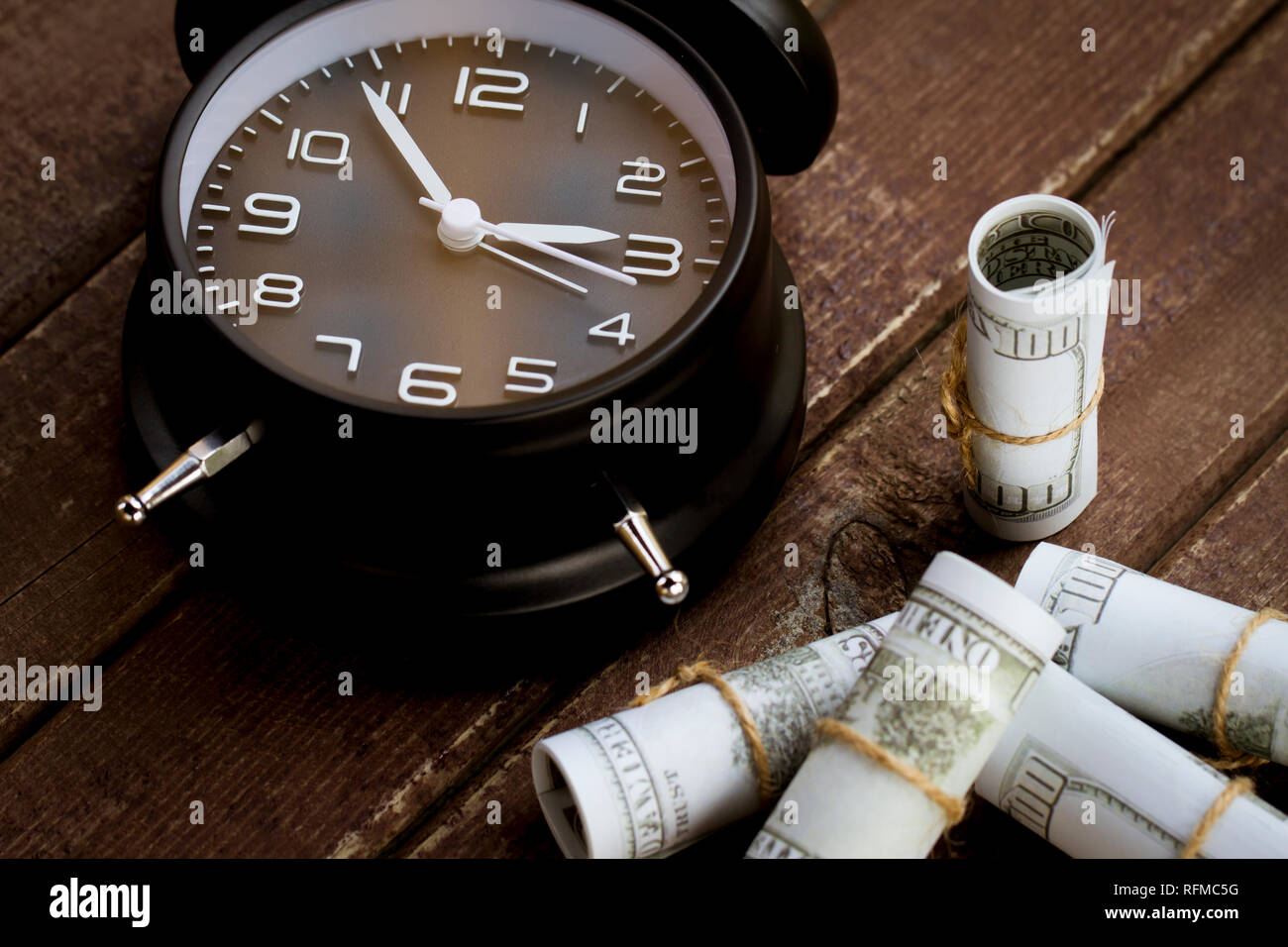 Clock and money, precious time Stock Photo - Alamy