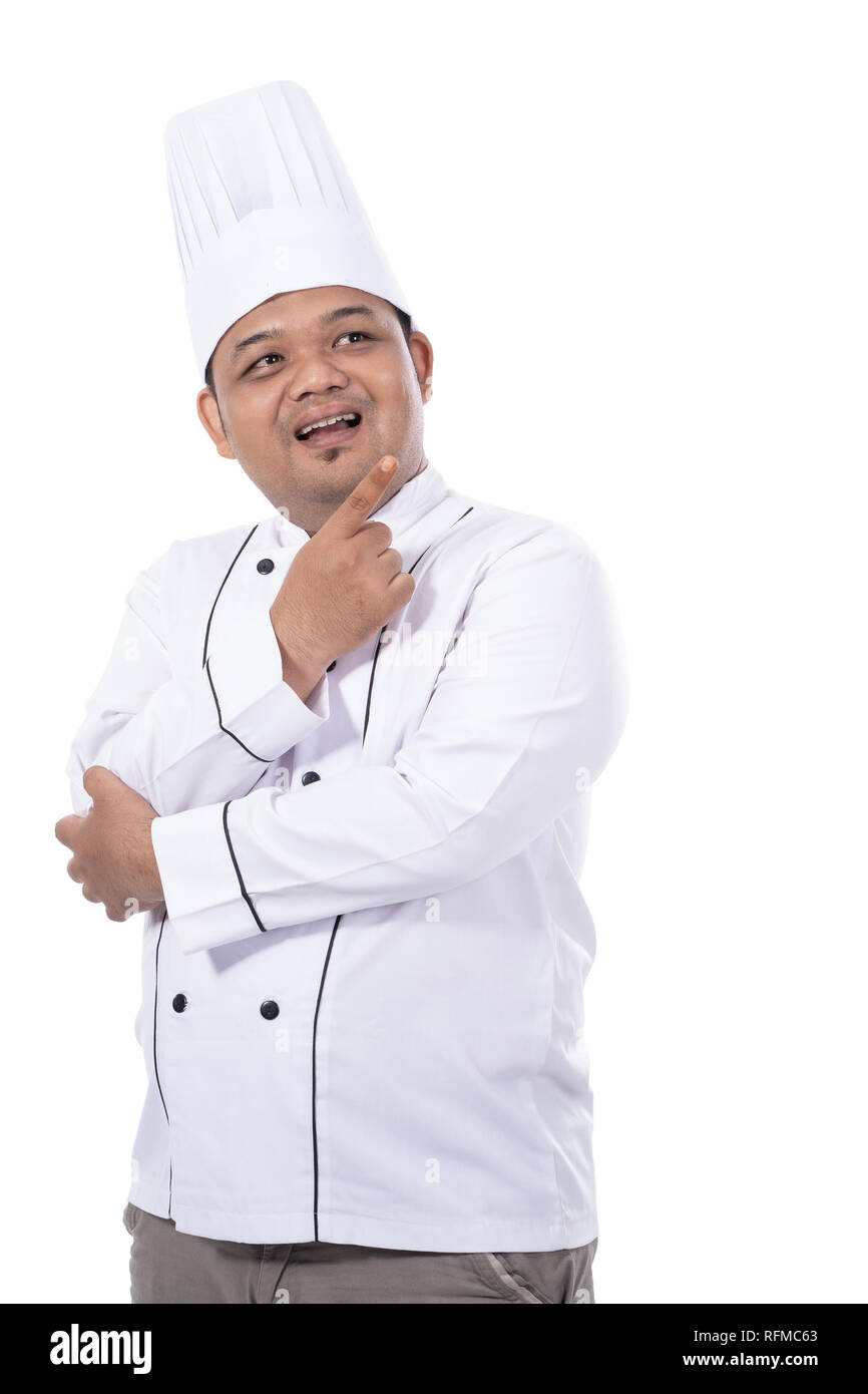 portrait of young male chef standing confident pose look at a front of ...