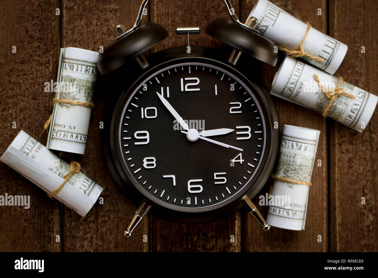 Clock and money, precious time Stock Photo - Alamy