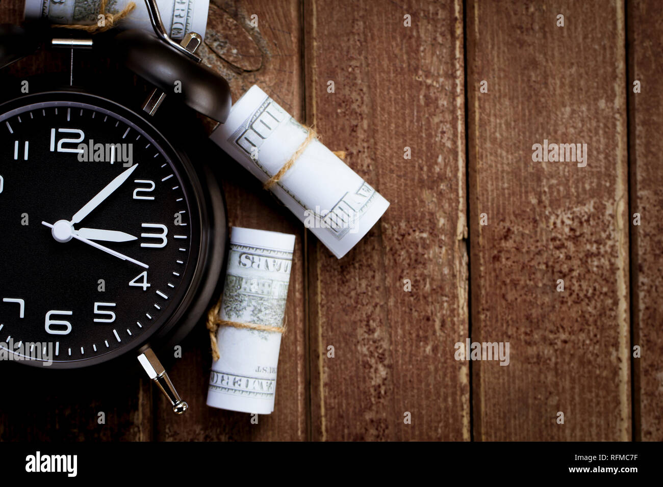 Clock and money, precious time Stock Photo - Alamy