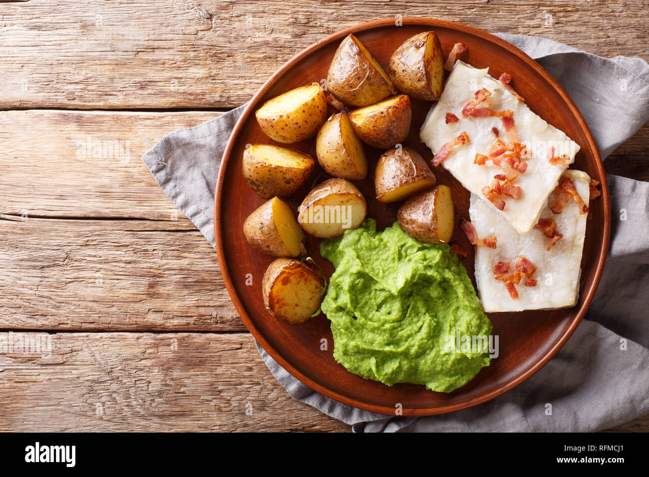 Popular Scandinavian food Lutefisk cod with pea puree, baked potatoes ...