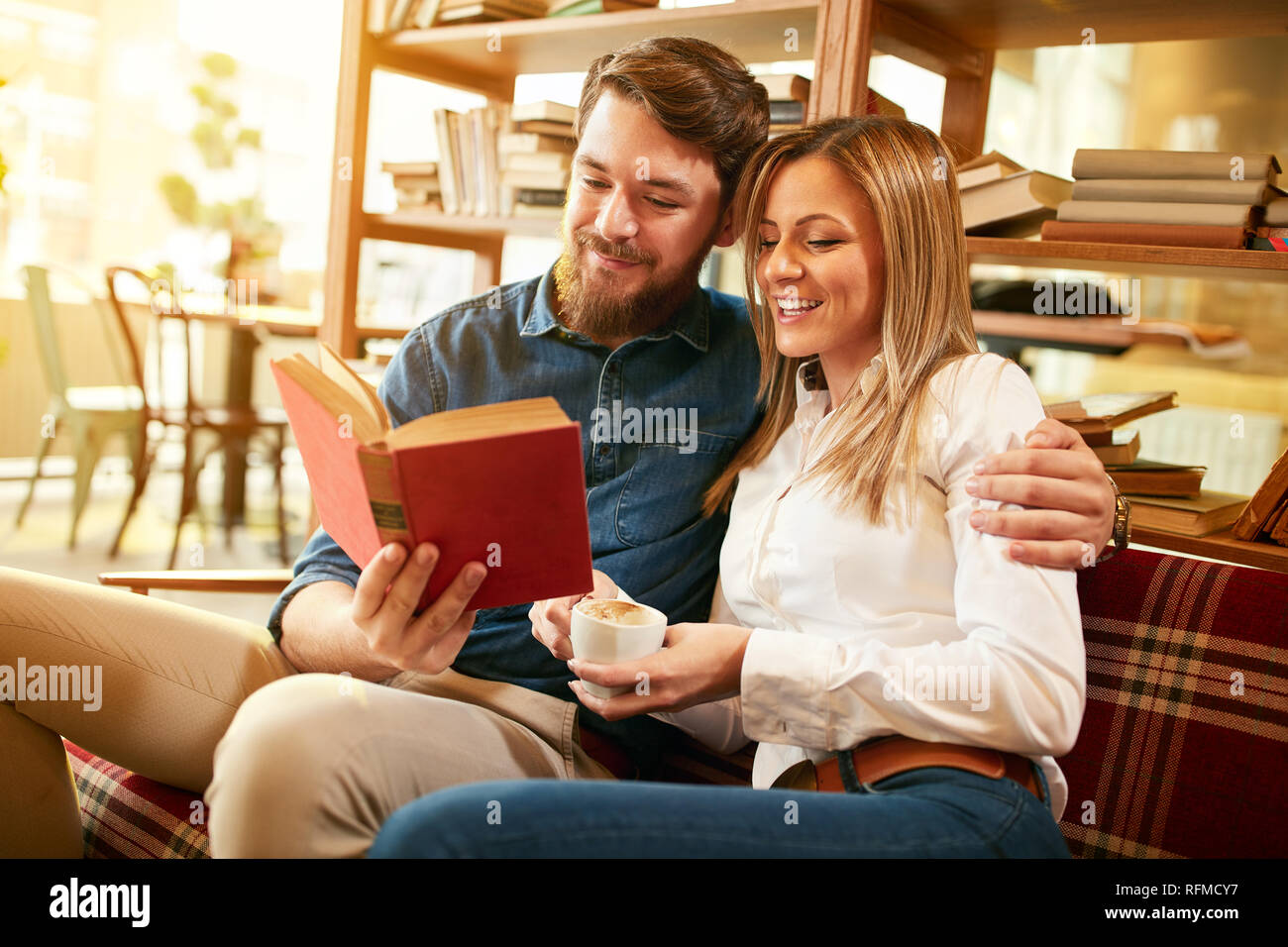 Hugging couple learn for exam in students club Stock Photo - Alamy