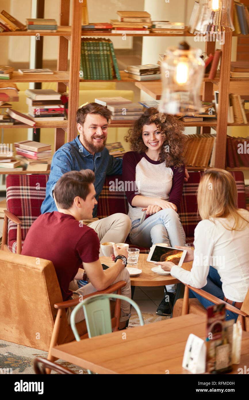 Two couple friendly talk in library Stock Photo - Alamy