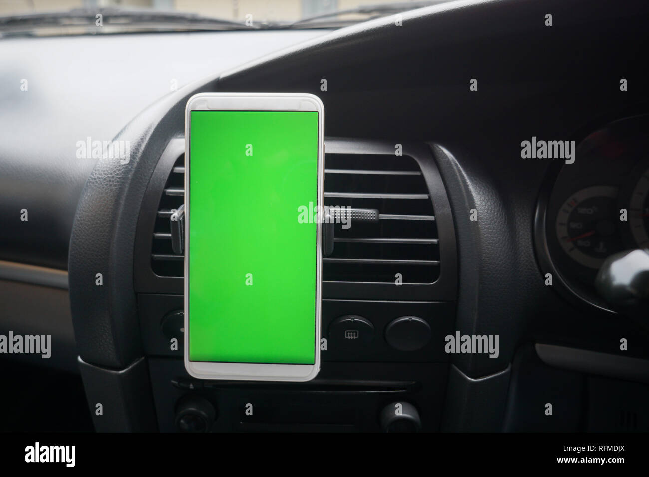 smartphone with green screen (Chroma key) with Car dashboard background ...