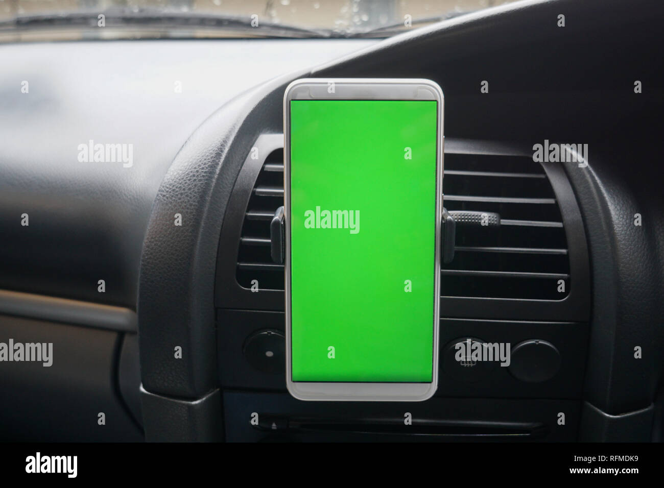 smartphone with green screen (Chroma key) with Car dashboard background ...