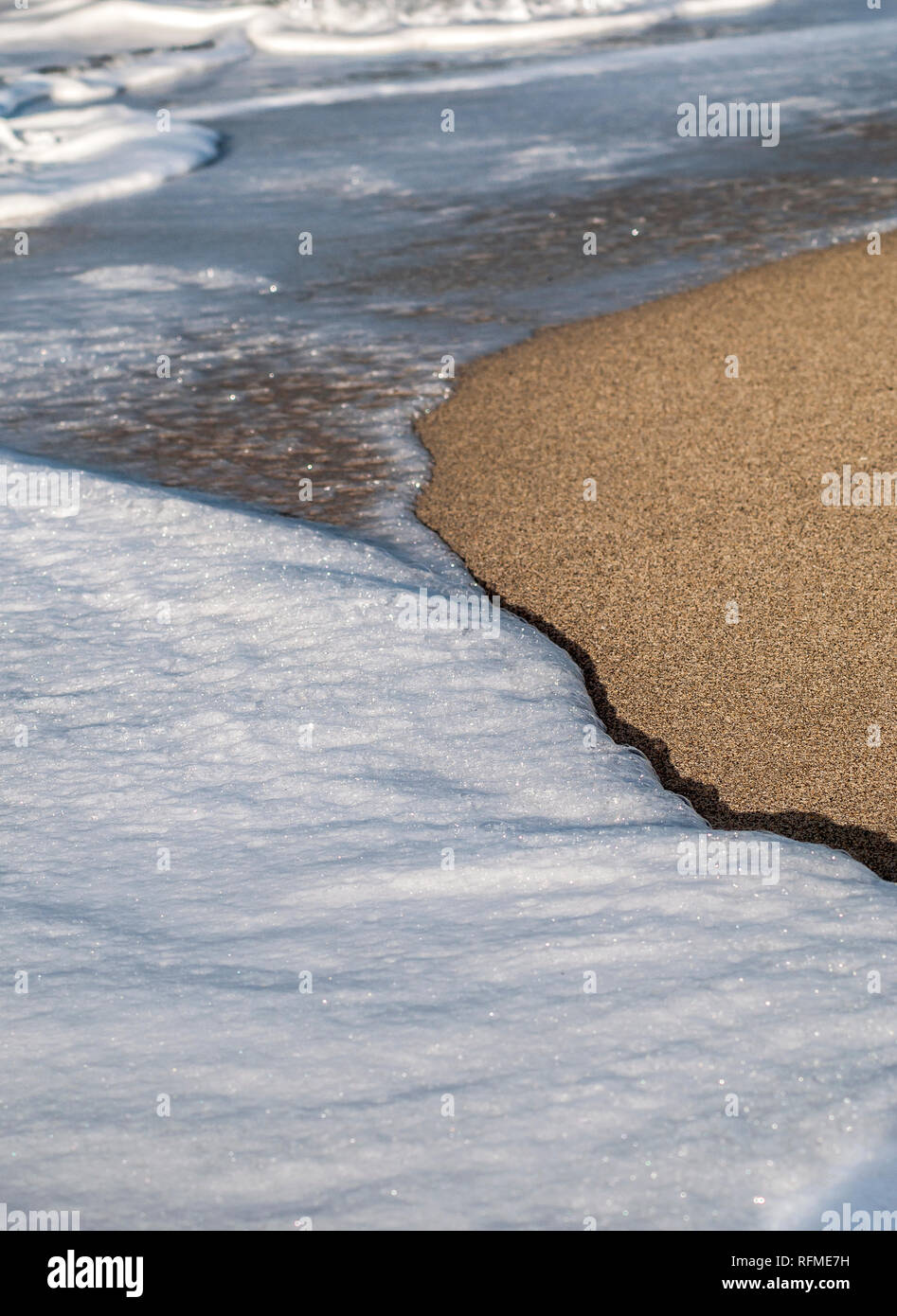 Shimmering sea foam remnants of a wave on Porthmeor surf beach ...